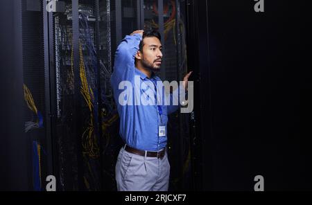 Server room, thinking and confused man with cables for connectivity ...