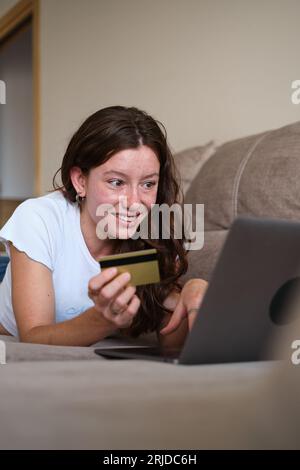 Young beautiful woman at home cheerful with a smile of face pointing ...