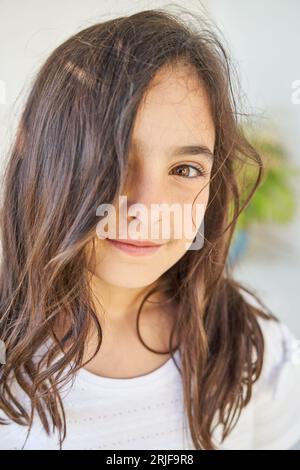 Portrait of preteen adorable child girl playing with her pet giant ...