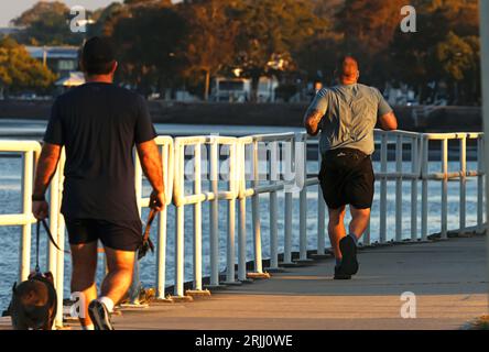Random people walking away from the camera. No faces, sports, healthy ...