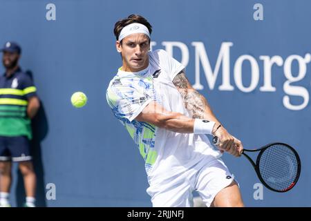 Camilo Ugo Carabelli of Argentina returns the ball during the Miami Open tennis tournament ...