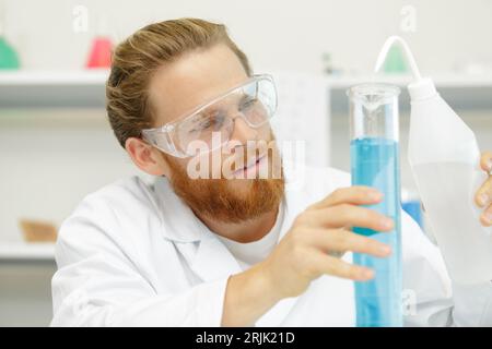 scientists working with large vat in the lab Stock Photo - Alamy