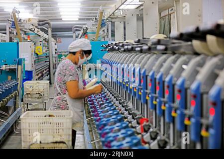 Female spinners on the production line Stock Photo - Alamy