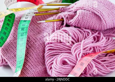 A selection of knitting supplies including yarn, needles, and a ...