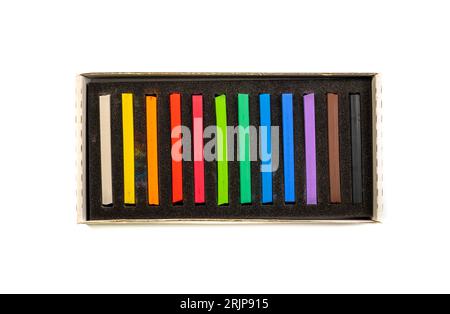 Set of soft pastels on white background in wooden box. Drawing material ...