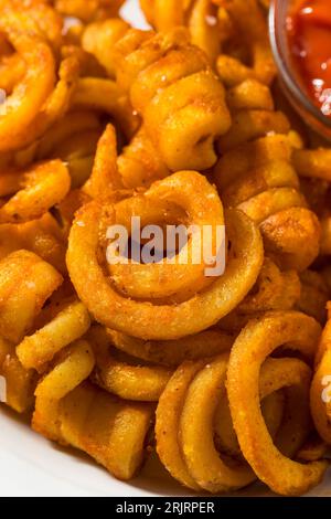 Seasoned Homemade Curly French Fries with Ketchup Stock Photo - Alamy