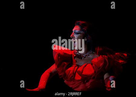 A transvestite performer in a drag queen show entertains an audience in ...