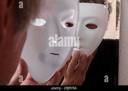 Self consideration through mask in a mirror Stock Photo - Alamy