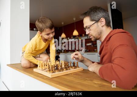 Father and son are playing chess at home Stock Photo - Alamy