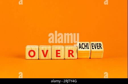Achiever or overachiever symbol. Businessman turns wooden cubes and ...