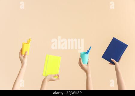 Hands holding school supplies on beige background Stock Photo - Alamy