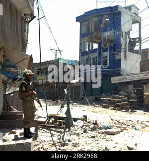 Soldiers patrol on a main street in Aden at the time of the troubles ...