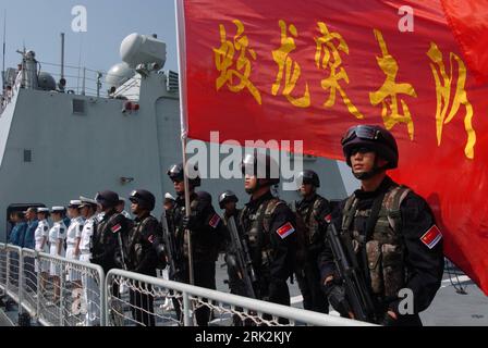Members of the deck force stand in formation on the deck of the frigate ...