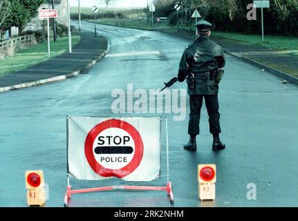 An RUC (Royal Ulster Constabulary) officer on patrol in the nationalist ...