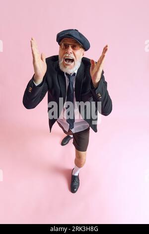 Photo of cool funky man pensioner dressed santa claus costume selling ...