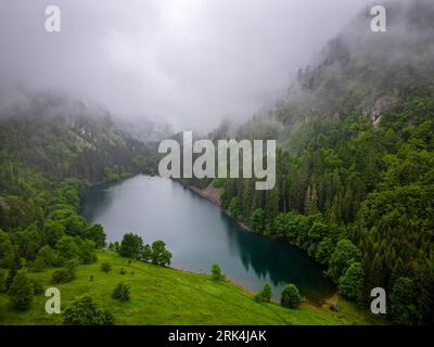 A picturesque view of Lake Susica surrounded by cloudy mountains Stock ...