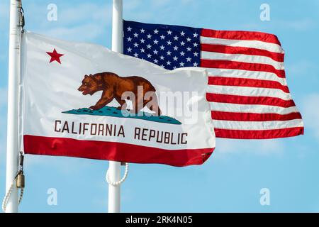 California Republic bear flag and US american flags floating on poles ...