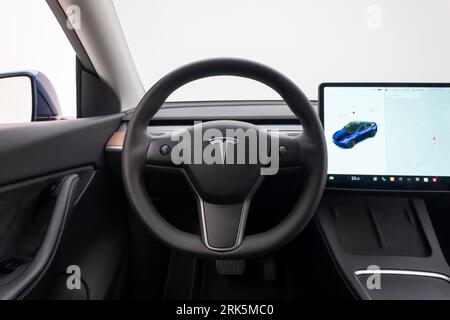 A close-up of an interior Tesla dashboard with a sleek, modern black ...