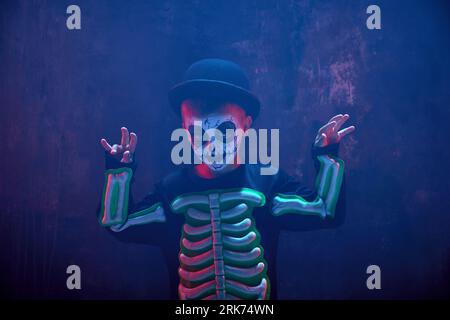 Little boy, child with creepy pale face makeup, wearing costume of ...
