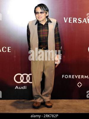 Hong Kong actor Teddy Robin poses as he arrives for the movie premiere ...