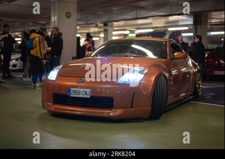 An iconic Nissan 350Z in orange color, in a concentration of Japanese ...