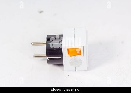 Close up of universal electric socket plug adapters, isolated on white ...