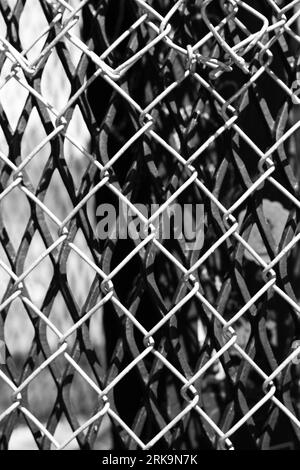 A typical metal chain link fence with a repeating pattern of steel ...
