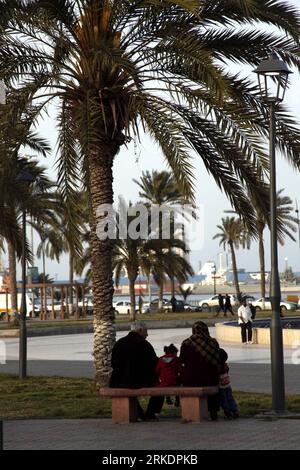 Local residents sit on the bench in the center of the recaptured by the ...