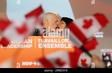 NDP Leader Jack Layton and his wife Olivia Chow make their way down the stairs of the campaign ...