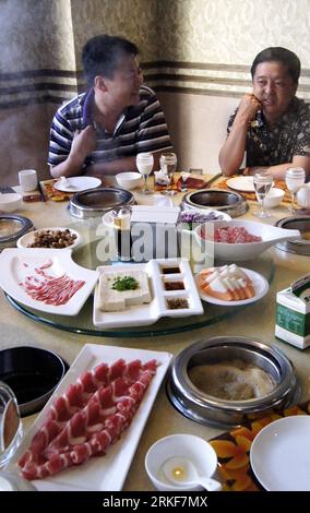 Chinese customers enjoy hot pot in an ice house built with ice blocks ...