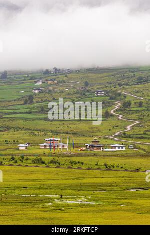 An idyllic landscape of Bhutan's countryside featuring a vibrant green ...