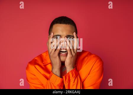 Shocked and concerned young man with red hair, staring at camera ...