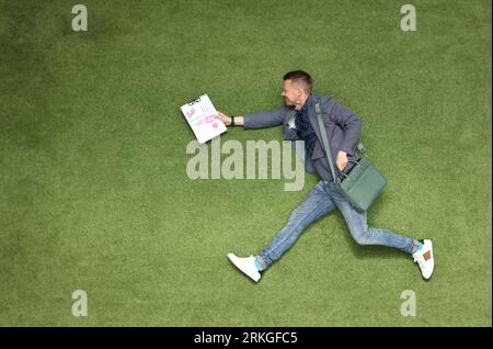 Young businessman happily running with work papers Stock Photo - Alamy