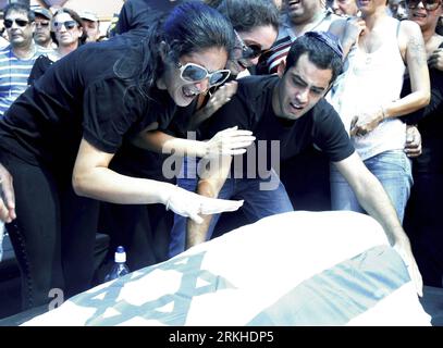 Viki Jan , daughter of Dov and Shula Karlinsky, mourns during their ...