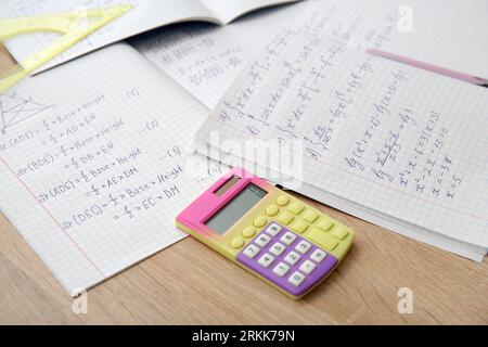 Open copybooks with math formulas and stationery on wooden table Stock ...