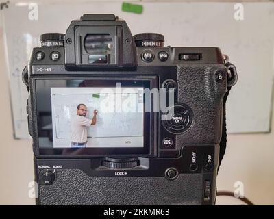 Teacher filming and streaming his lessons for the students through ...