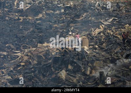 Firefighters work to extinguish a fire which broke out Wednesday at ...