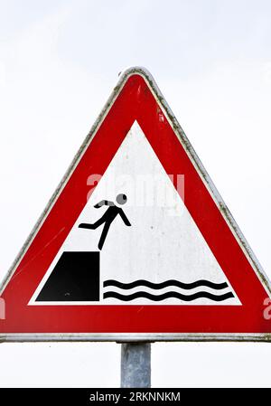 Danger sign warning of risk of falling trees, with DANGER highlighted ...