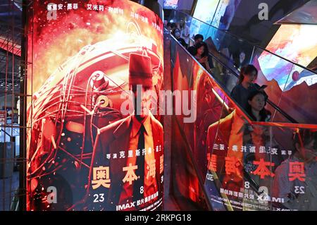 SHANGHAI, CHINA - AUGUST 25, 2023 - Visitors pass a poster of the film ...