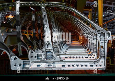 Passenger car carcass parts on assembling conveyor at plant Stock Photo ...