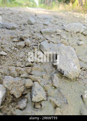 dried up puddle left with stones along the pathway Stock Photo - Alamy