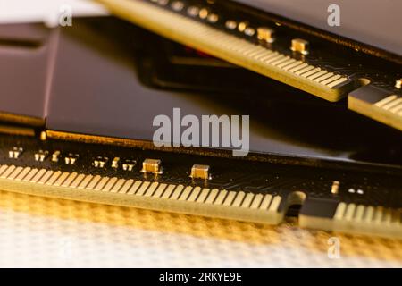 Memory module DDR4 DRAM with electrical contacts in blue light. Computer RAM chipset close-up ...