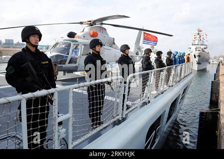 Members of the deck force stand in formation on the deck of the frigate ...