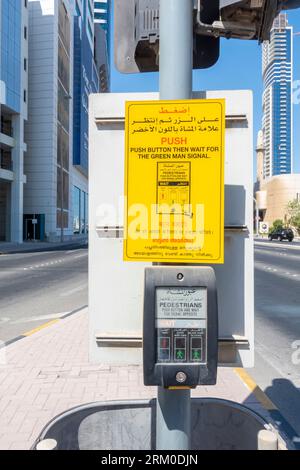 Push button crossing box for pedestrians in Bahrain Bilingual signs ...