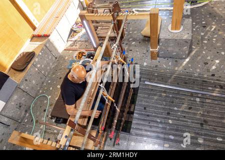 A weaving master operates the weaving textile machine at Naseej weaving ...