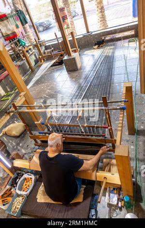 A weaving master operates the weaving textile machine at Naseej weaving ...