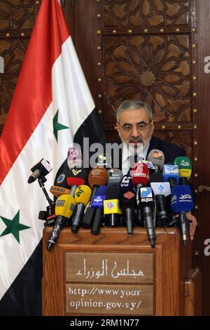 Syrian Information Minister Omran al-Zoubi speaks to the press before a ...