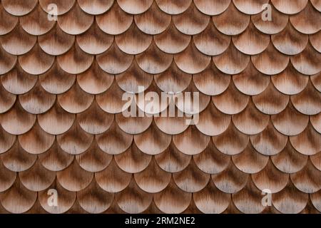 Wooden round bottom shingles of wall siding of historic farmhouse. Wood ...