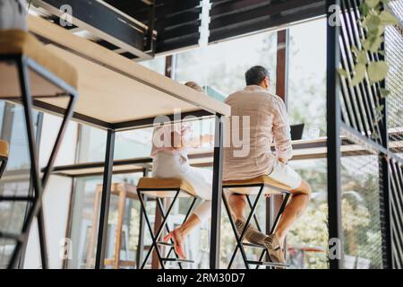 Achieving better results together. a group of colleagues using a laptop ...
