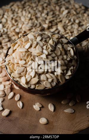 overhead view of nigerian egusi seeds in a brown bowl, shelled melon ...